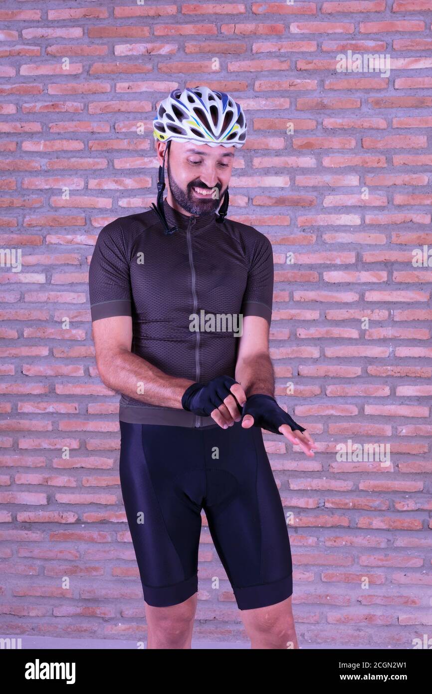 Young handsome cyclist putting hi-res stock photography and images - Alamy