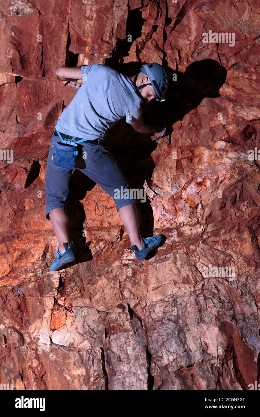 Courageous hispanic male climber carefully looking down Stock Photo - Alamy