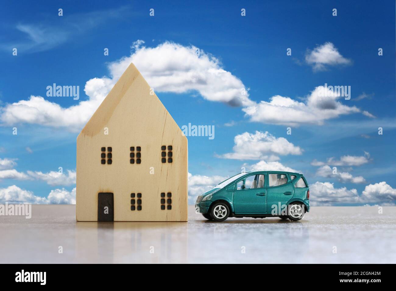 Wooden house and toy cars on the floor concept of having property as a ...
