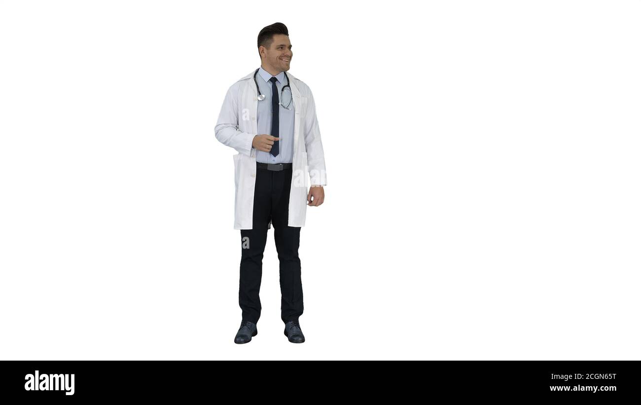 Happy doctor showing something near him and smiling on white background ...