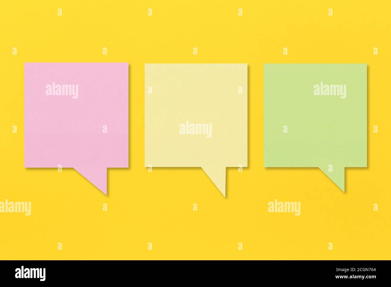 Colorful square note paper on yellow paper background and have copy ...