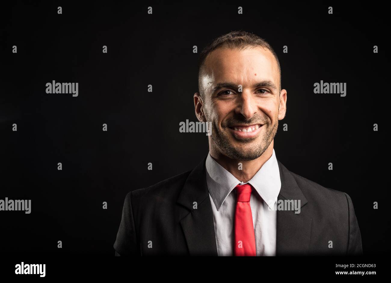 Handsome and smiling man in suit. Close up. Black background Stock ...