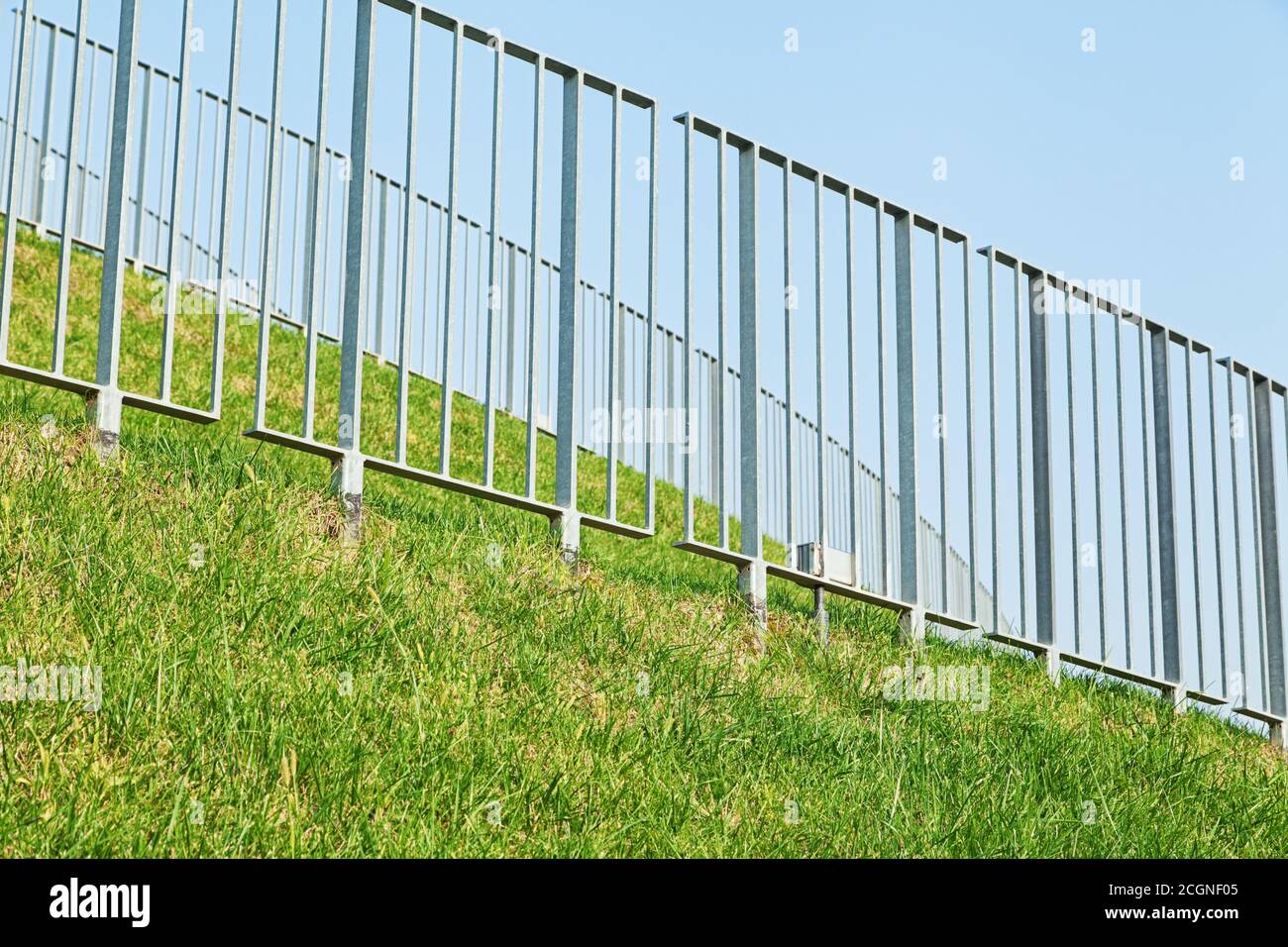 Many steel guards with green grass and blue sky Stock Photo - Alamy