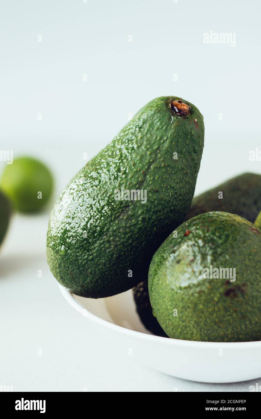 Fresh organic avocado in white ceramic bowl Stock Photo - Alamy