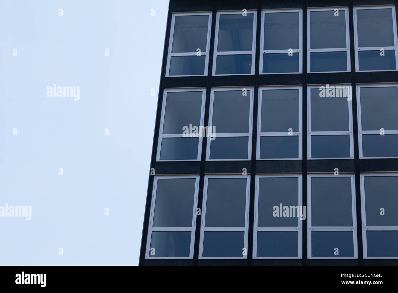 Part office building windows in frames with blue sky and copy space ...