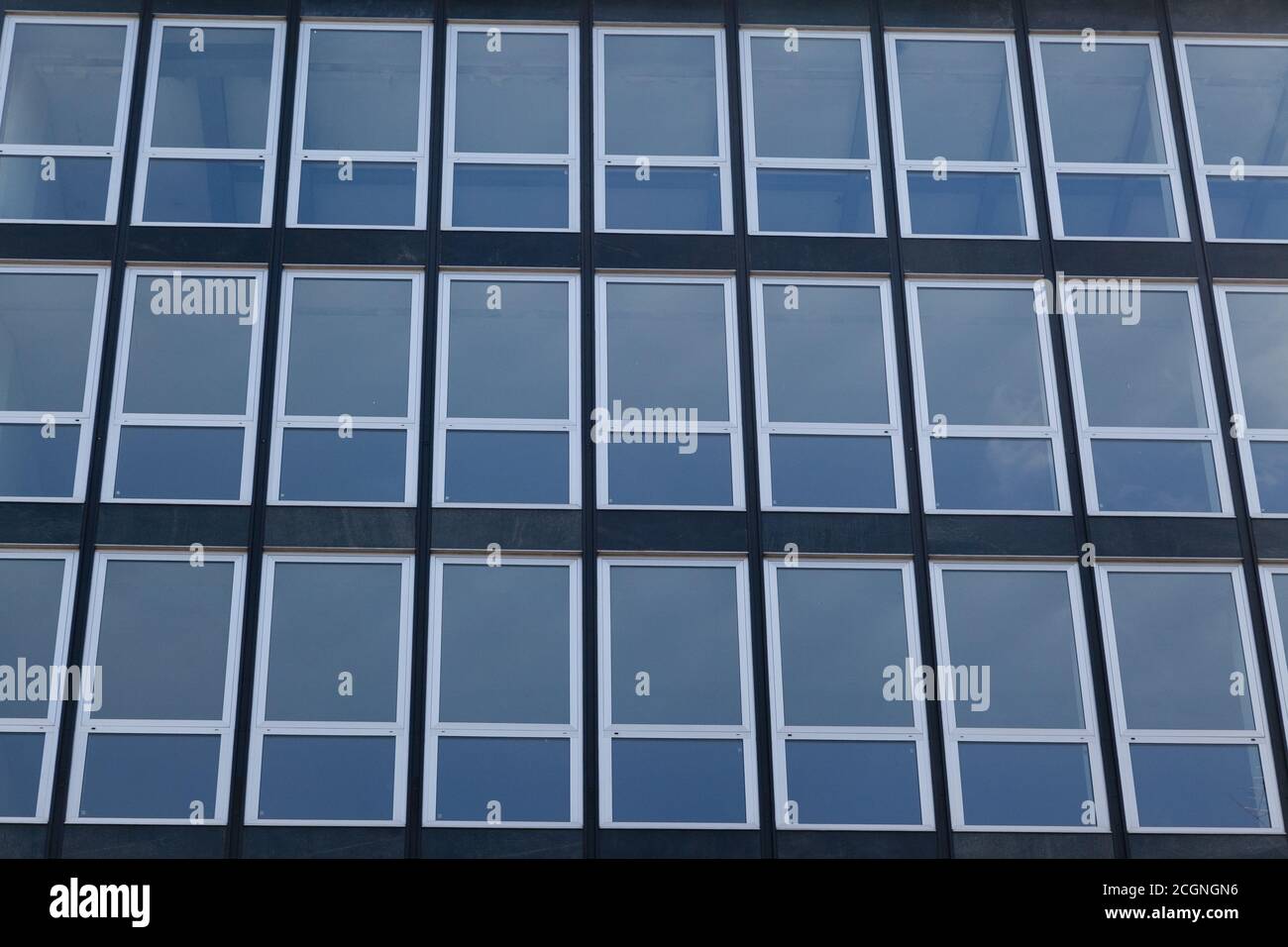 Horizontal row of office building windows in frames Stock Photo - Alamy