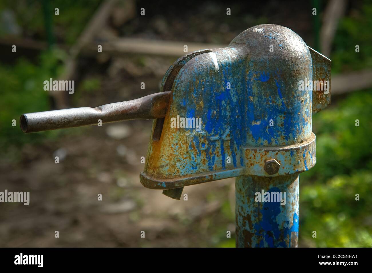 Old metal water pump on russian slum village Stock Photo - Alamy