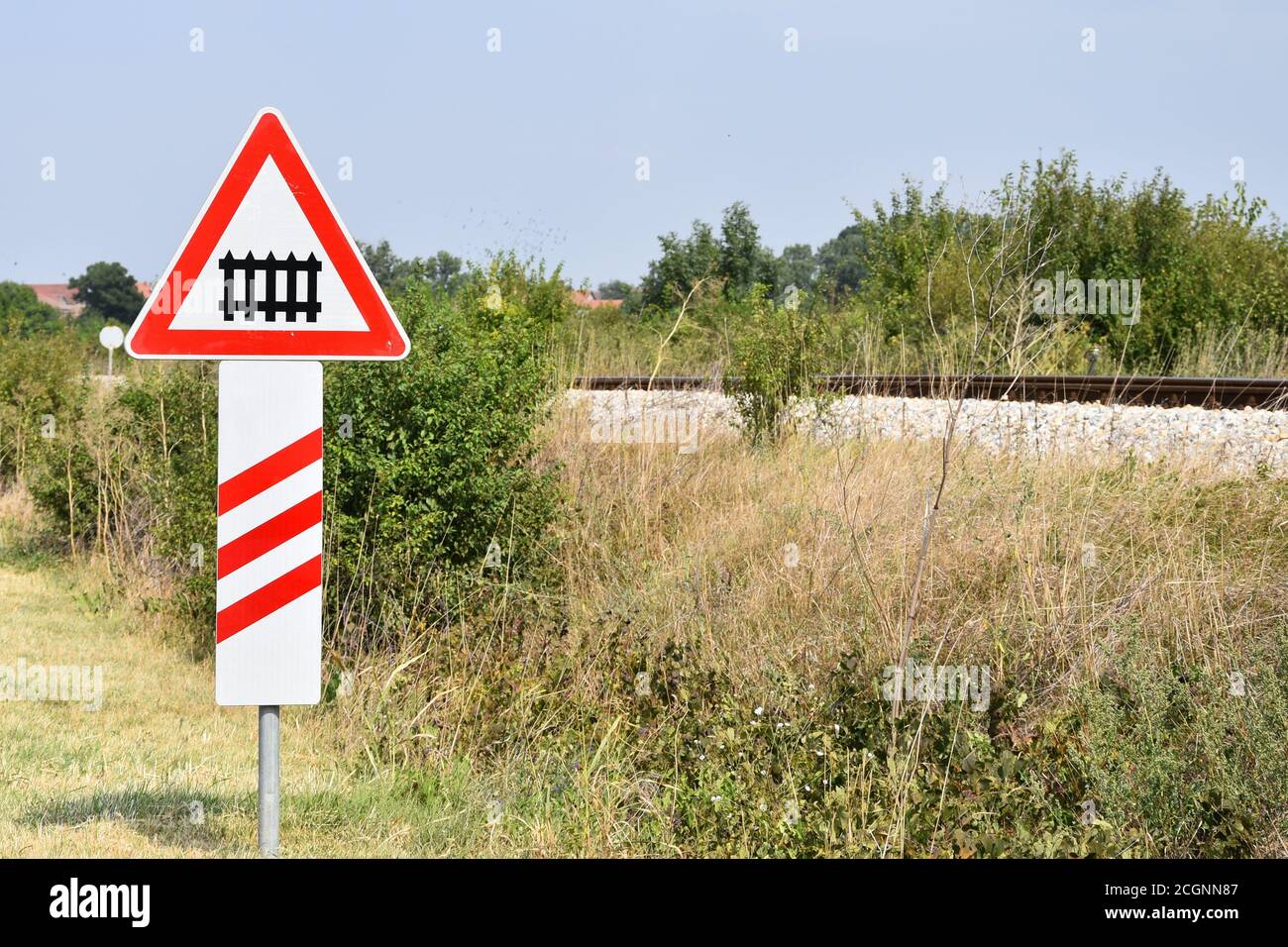 Warning road sign that informs driver of approaching railway crossing ...