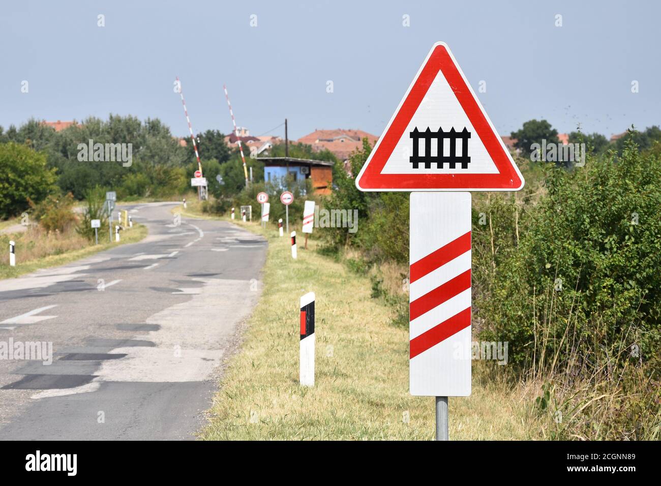 Warning road sign that informs driver of approaching railway crossing ...
