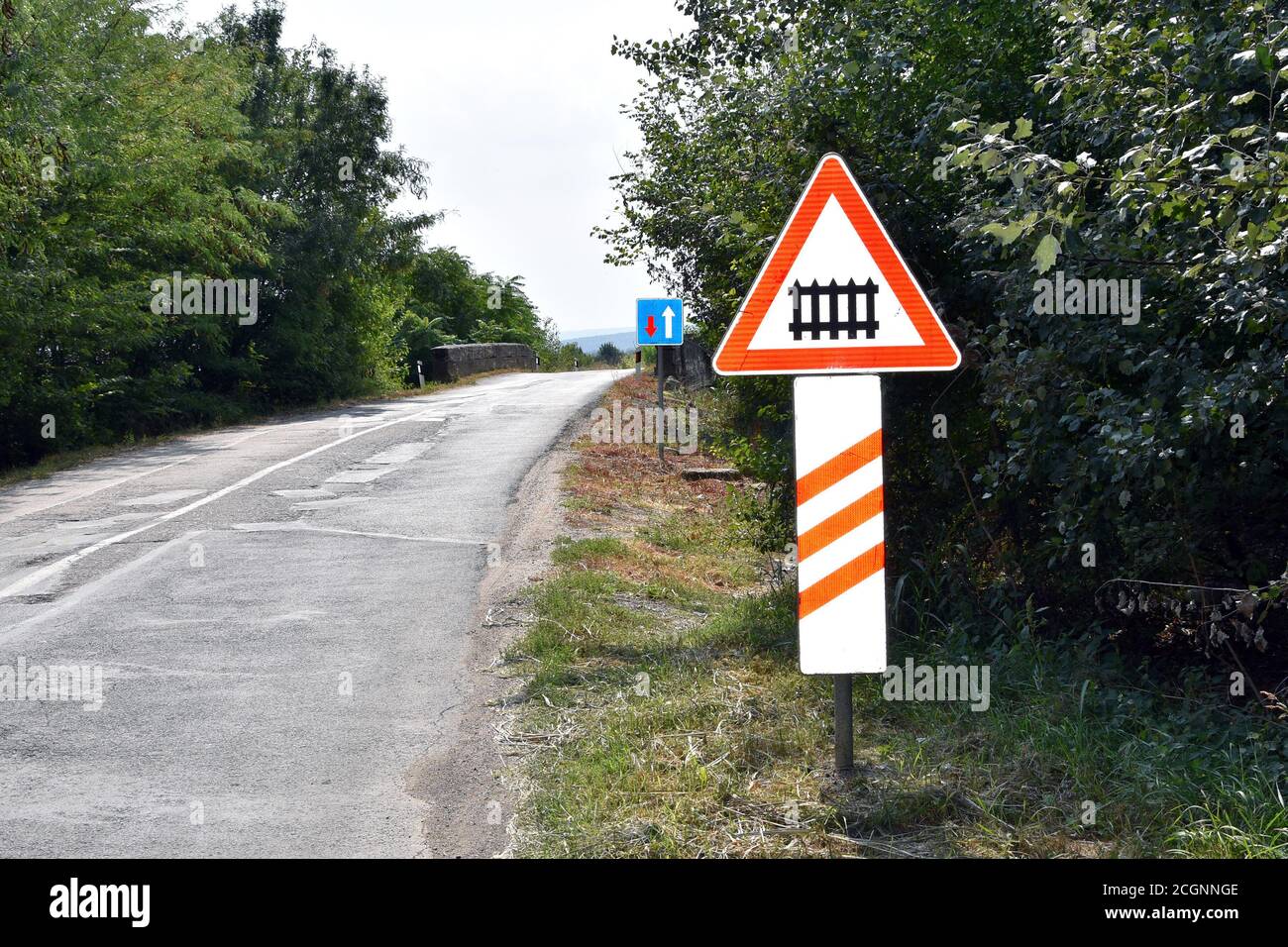 Warning road sign that informs driver of approaching railway crossing ...