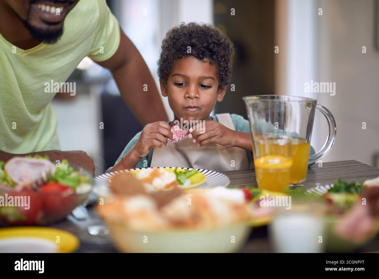 little african boy eating ham with his fingers Stock Photo - Alamy