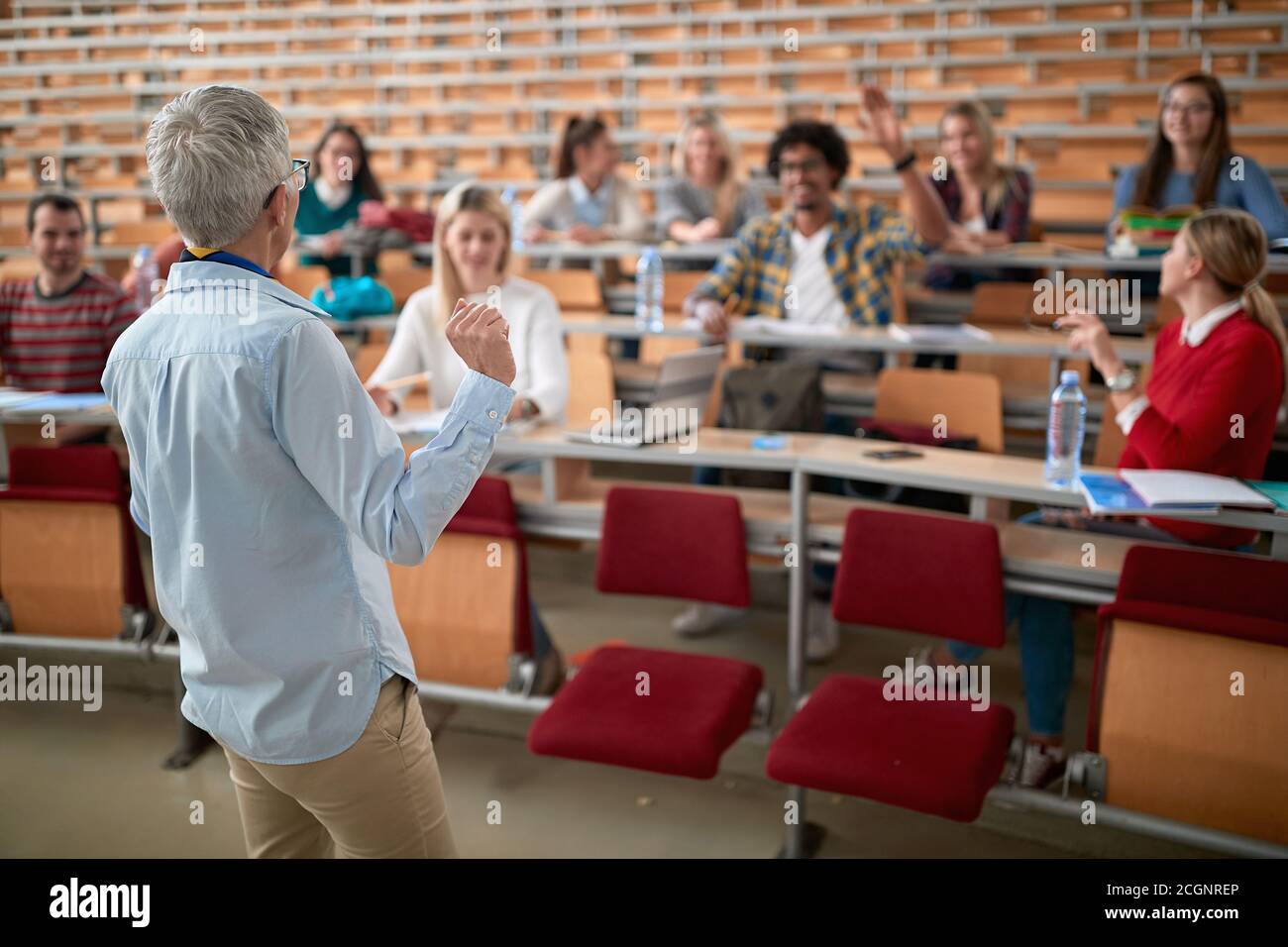 Female professor lecturing the students in amphitheatre Stock Photo - Alamy