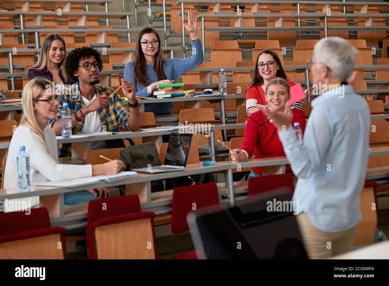 Students answering the questions of a female professor at a lecture in ...