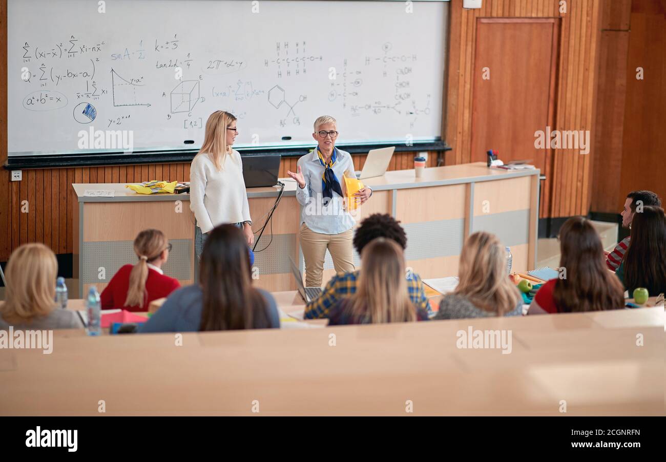 Female professor explaining the lesson to the students at a lecture in ...