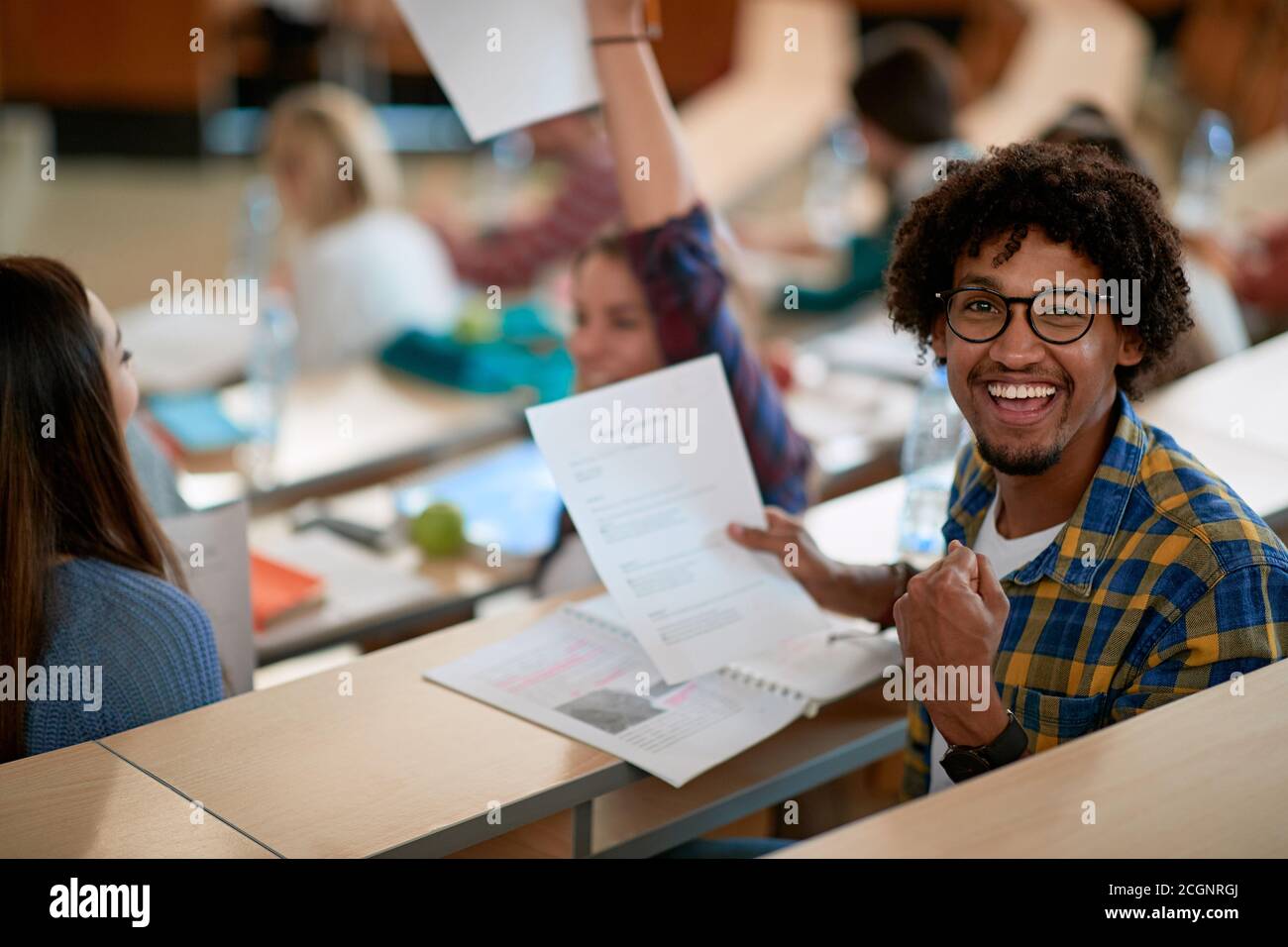 Young male student happy about his scores of the exam in an ...