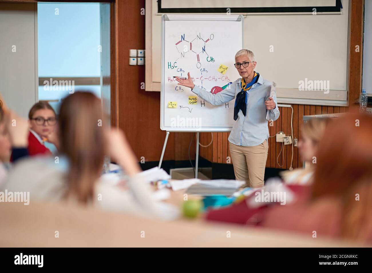 Female professor giving lecture in an amphitheatre Stock Photo - Alamy