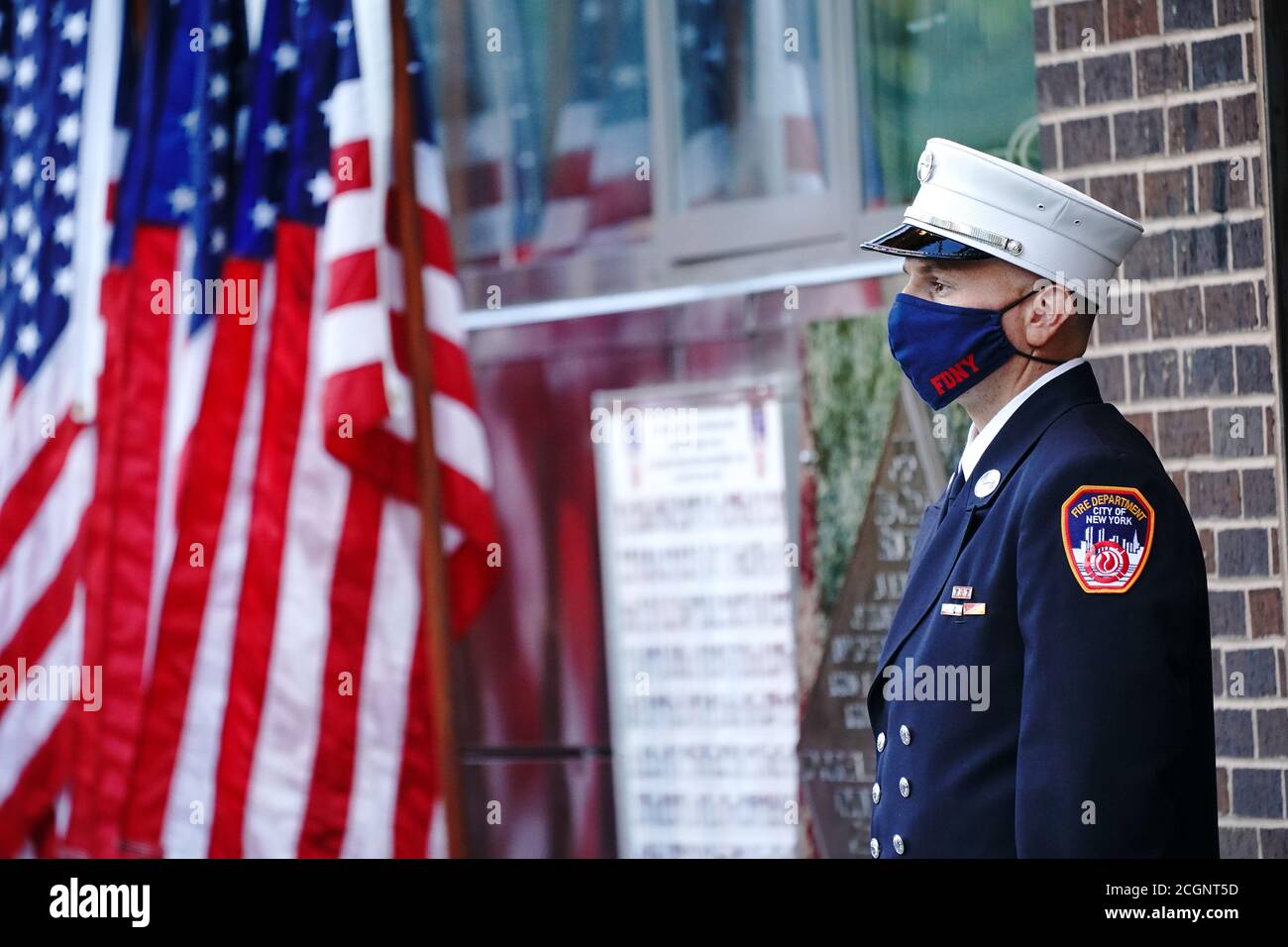 A FDNY personnel wearing a face mask stands on guard at 9/11 ...