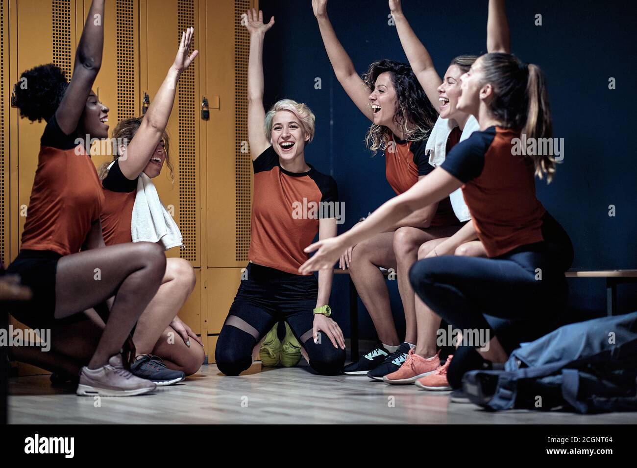 Female team in a locker room happy after the win Stock Photo - Alamy
