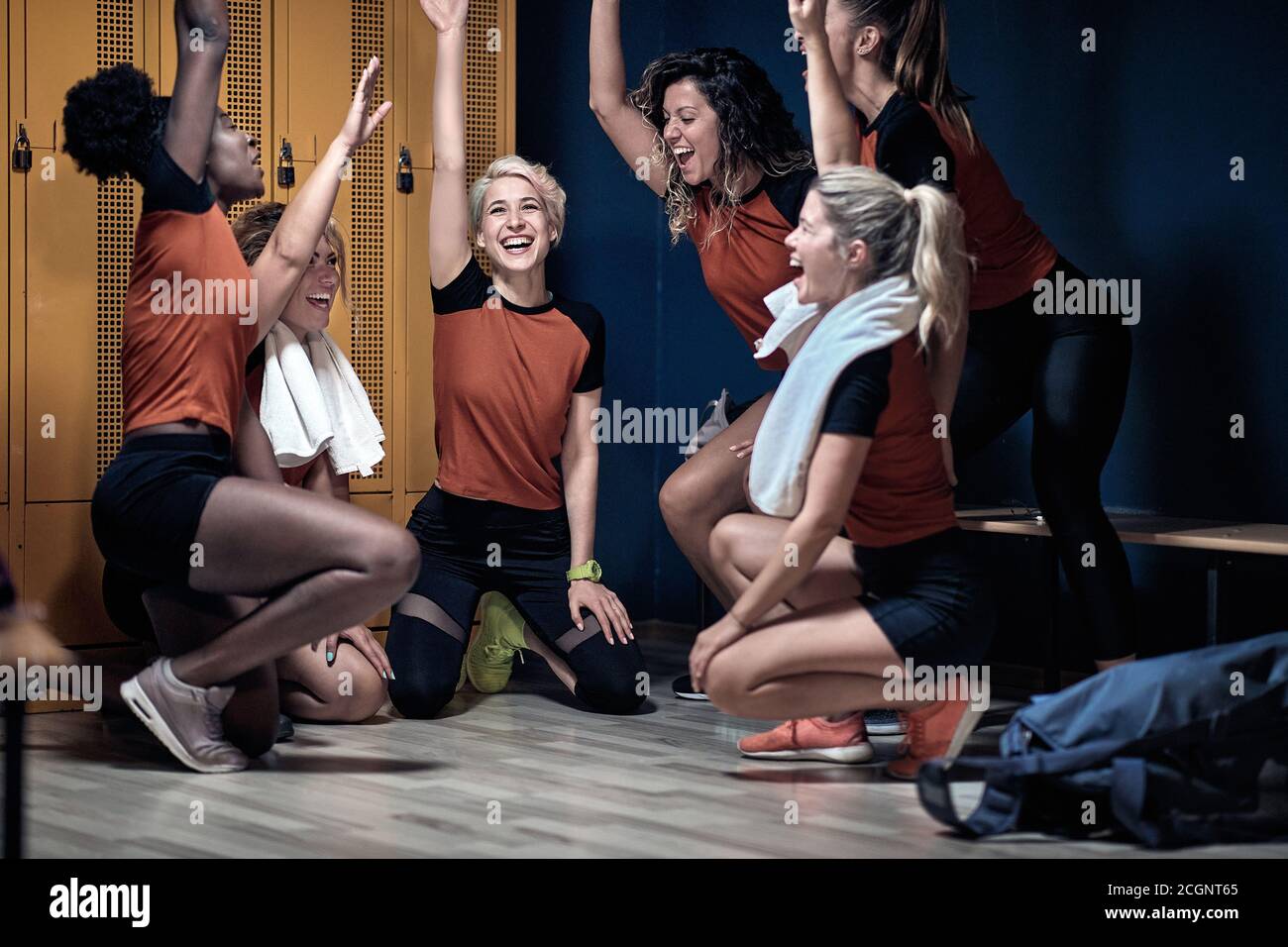Female team in a locker room celebrating the win Stock Photo - Alamy