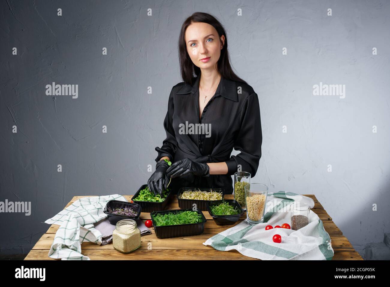 Packing green sprouts in containers by woman Stock Photo - Alamy
