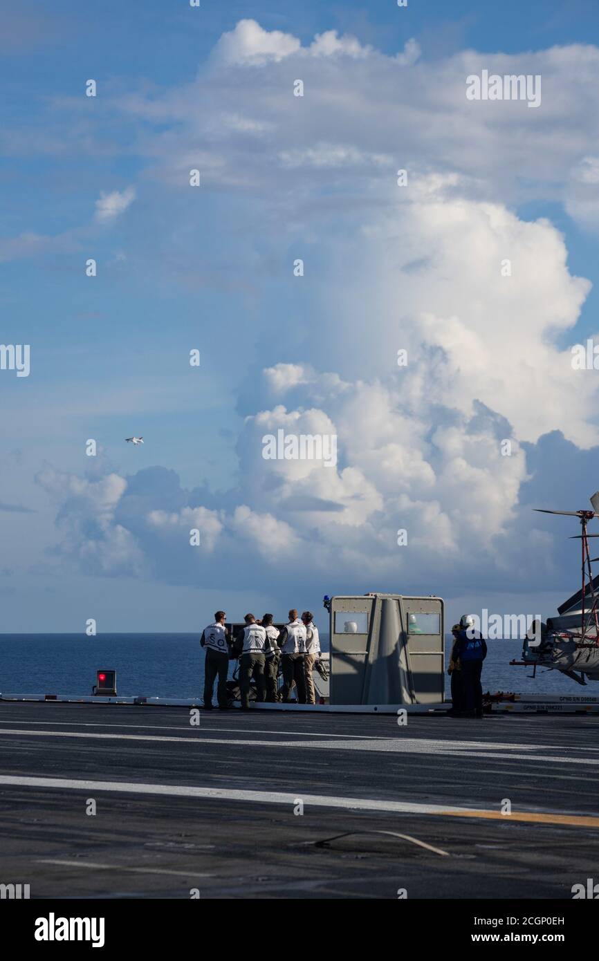 Landing Signal Officers (LSO) guide a A T-45C Goshawk, on it’s approach ...