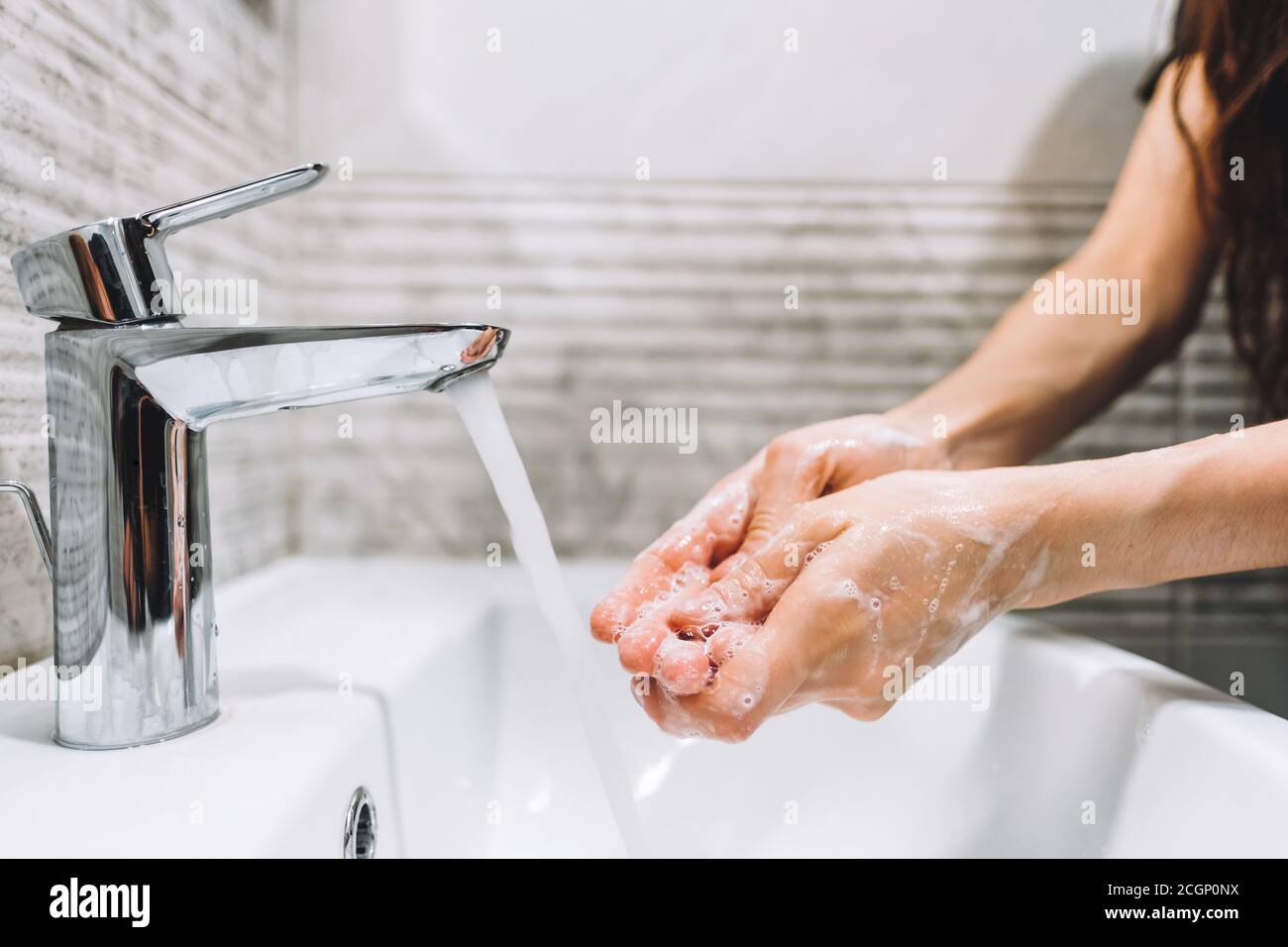 Woman cleaning hands with soap tap for viral diseases, coronavirus ...