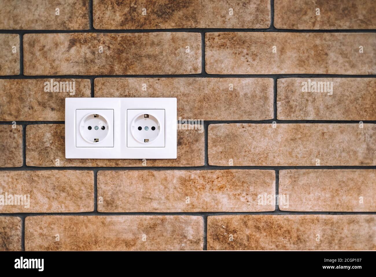 Power socket on the stone brick wall with copy space Stock Photo - Alamy