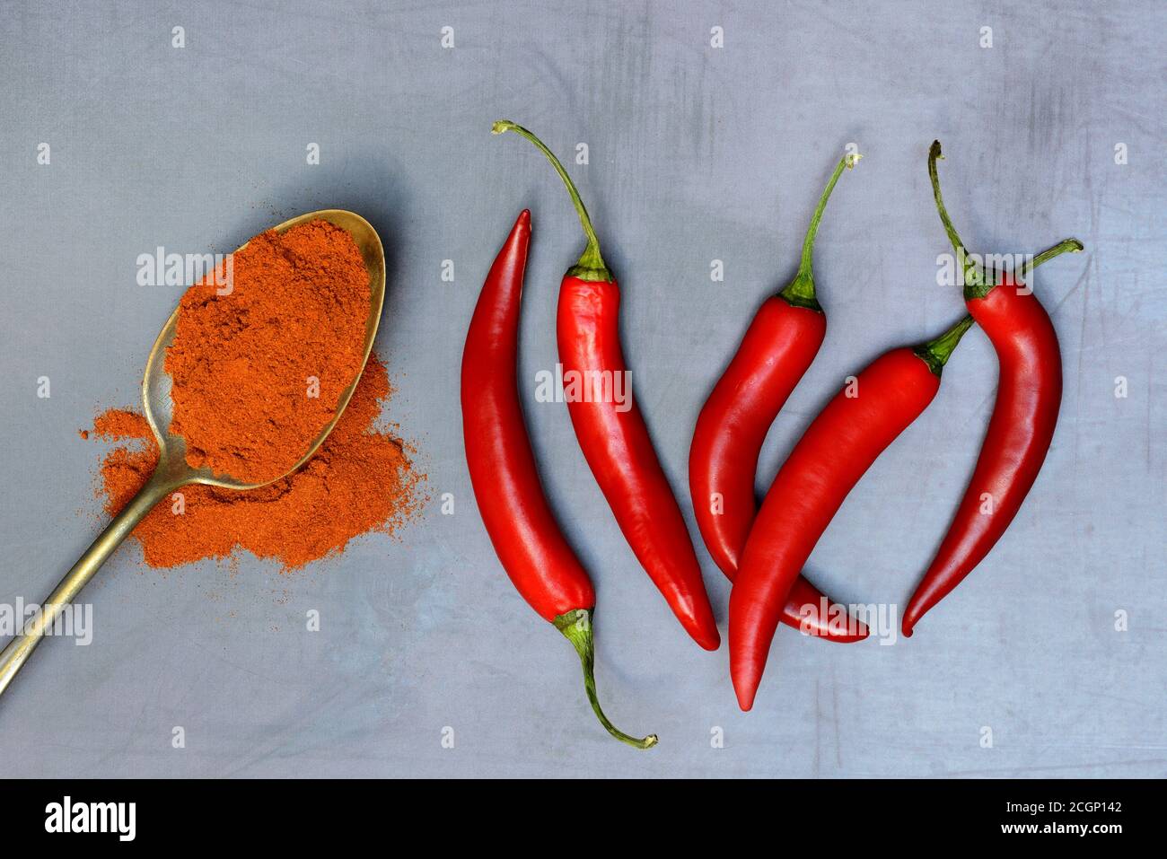 Chili powder in spoon and chilli peppers, Germany Stock Photo - Alamy