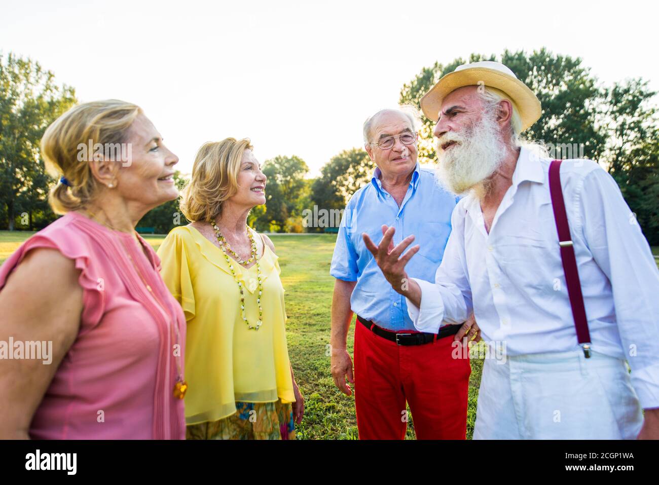 Group of youthful seniors having fun outdoors - Four pensioners bonding ...