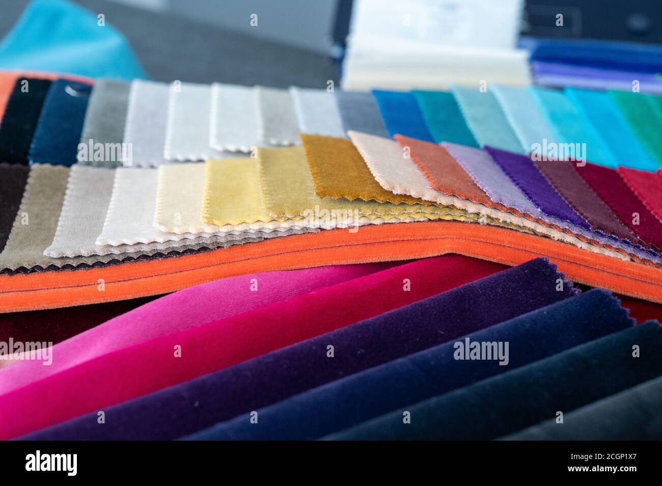 A table filled with soft luxury colorful folded velvet samples Stock ...