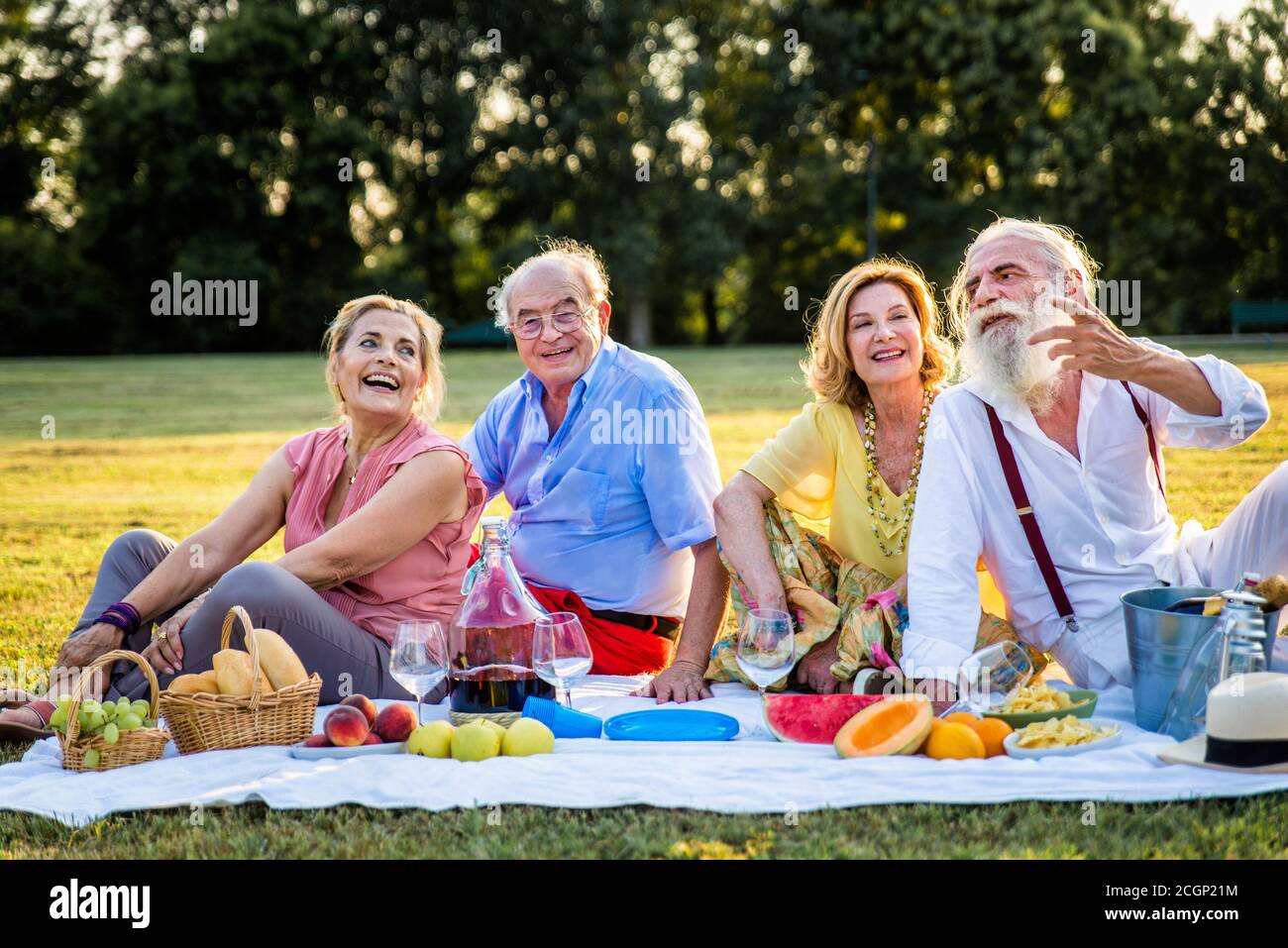 Group of youthful seniors having fun outdoors - Four pensioners bonding ...