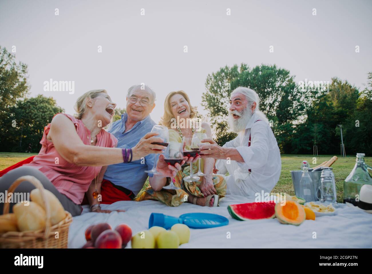Group of youthful seniors having fun outdoors - Four pensioners bonding ...