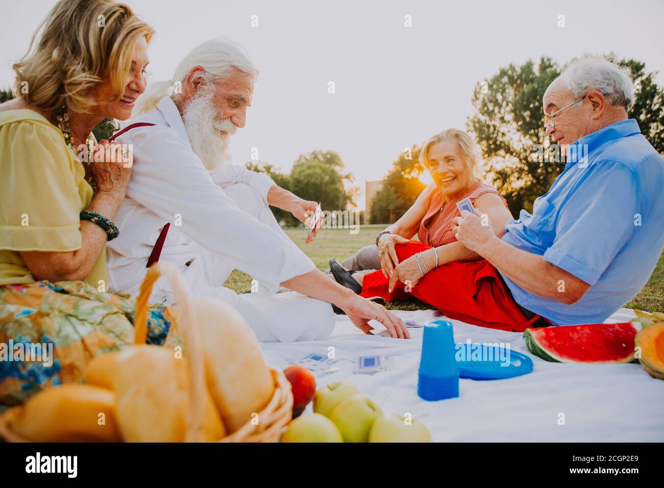 Group of youthful seniors having fun outdoors - Four pensioners bonding ...