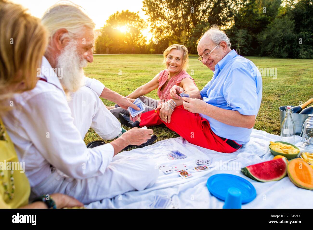 Group of youthful seniors having fun outdoors - Four pensioners bonding ...