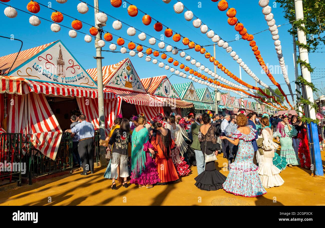 Celebrating spaniards in traditional dress in front of marquees hi-res ...