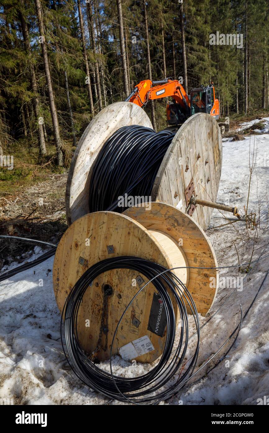 Wooden rolls of electrical and fiber optical cable waiting for digging ...