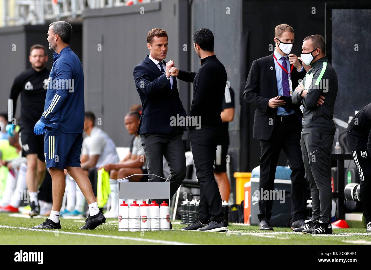 Fulham manager Scott Parker (left) fist bumps Arsenal manager Mikel ...