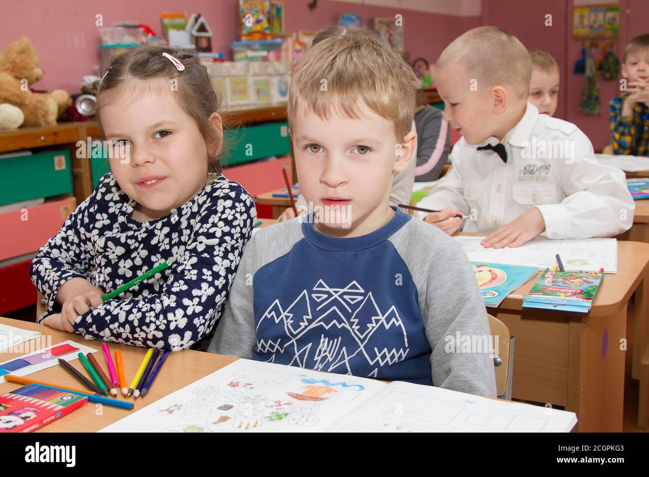 Children sit at desks in the classroom Stock Photo - Alamy