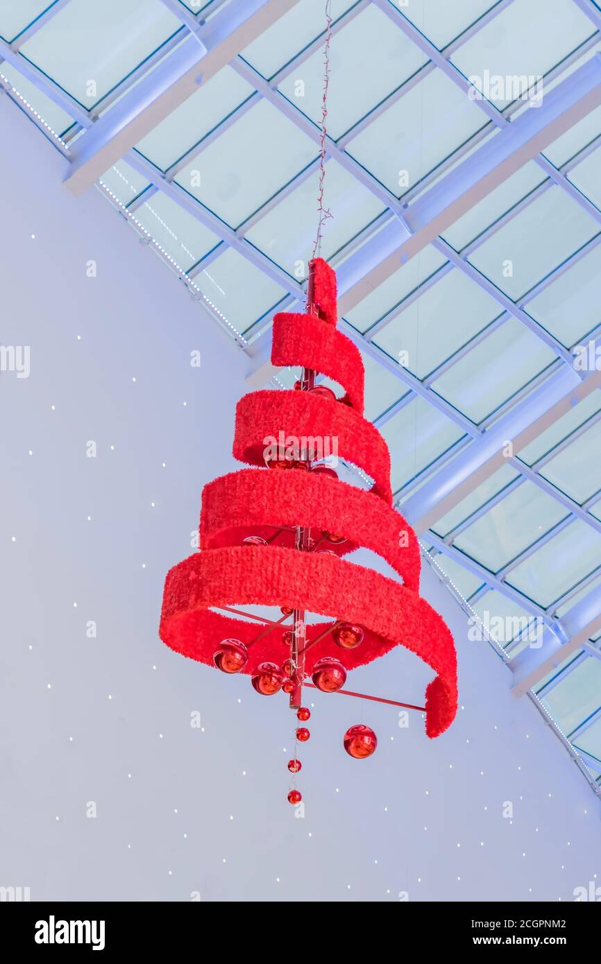 red xmas tree and garland hanging on ceiling closeup Stock Photo - Alamy