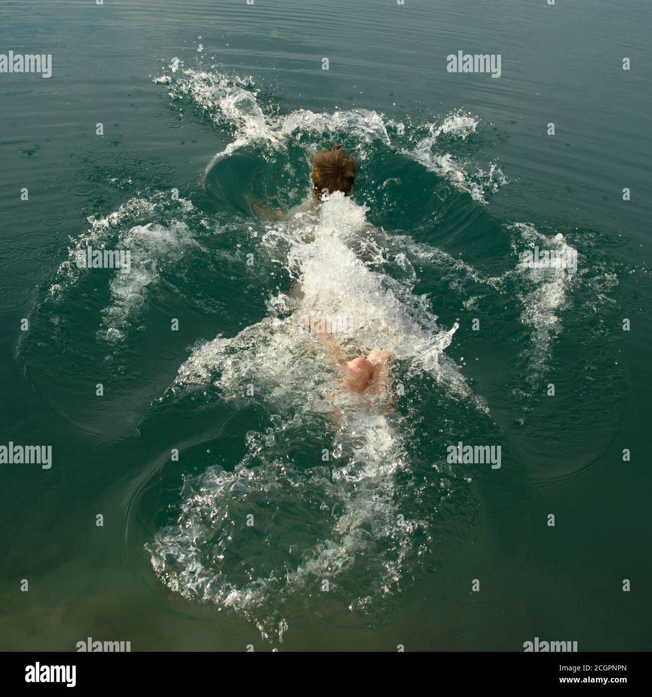 Splashes after jumping into the water Stock Photo - Alamy