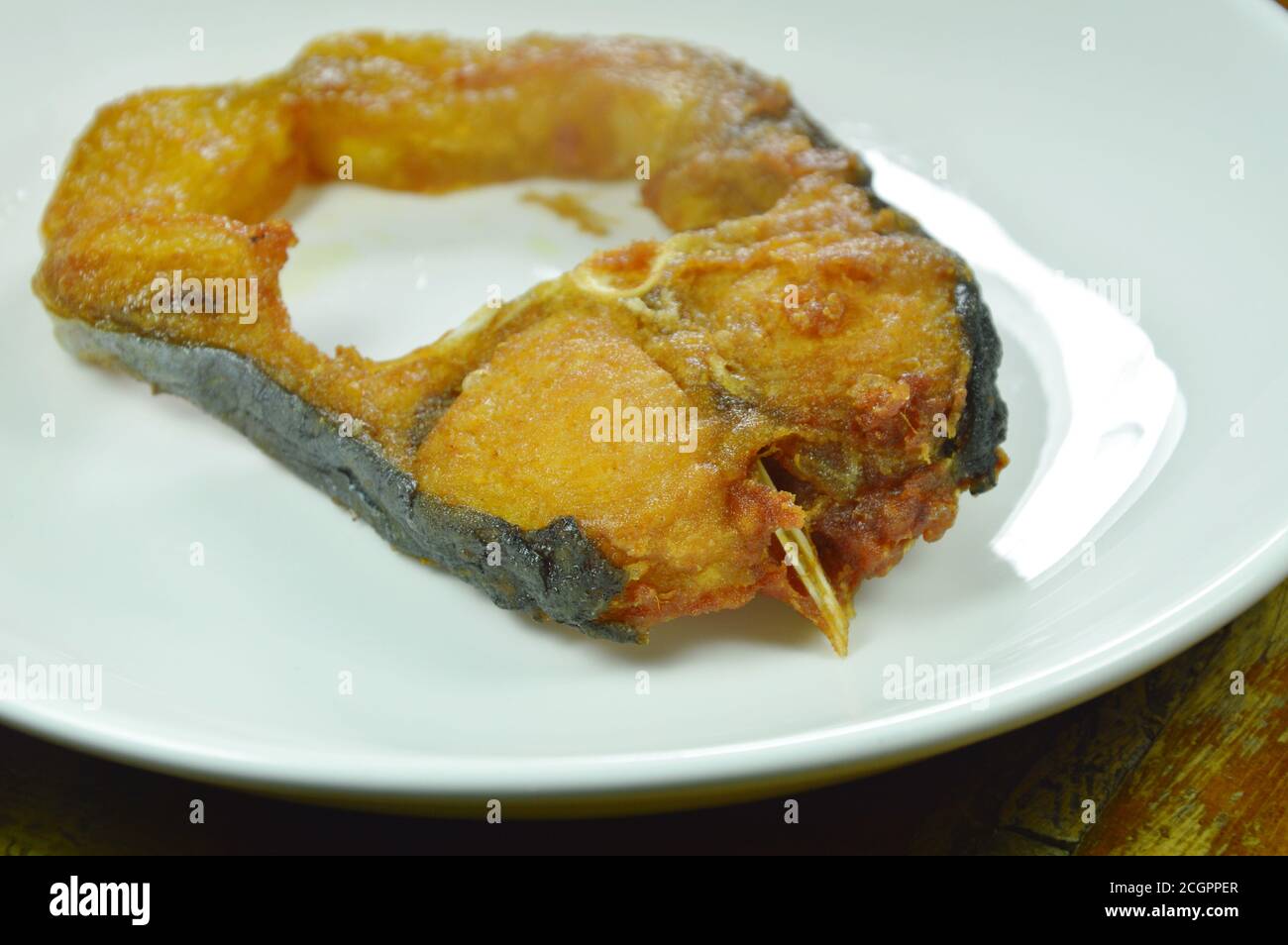 fried salty striped catfish slice on white plate Stock Photo - Alamy