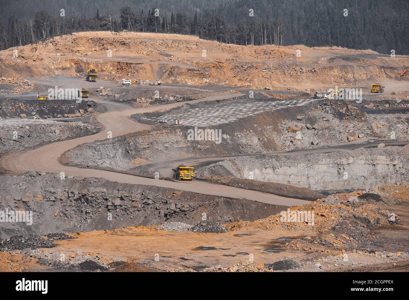 Big yellow mining truck transportation of gold ore. Open pit mine ...