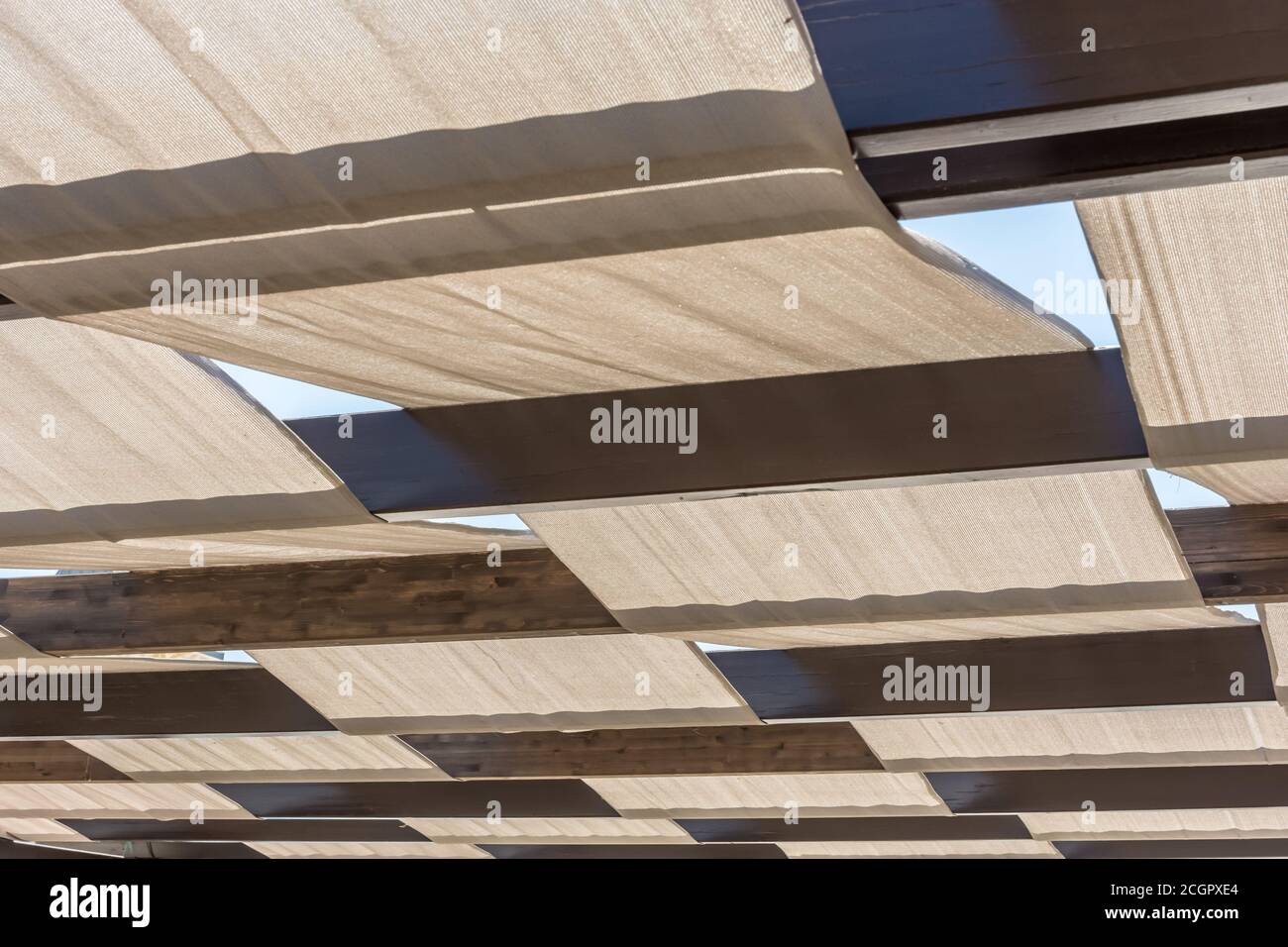 Large terrace roof with fabric panels and wooden beams for sun ...