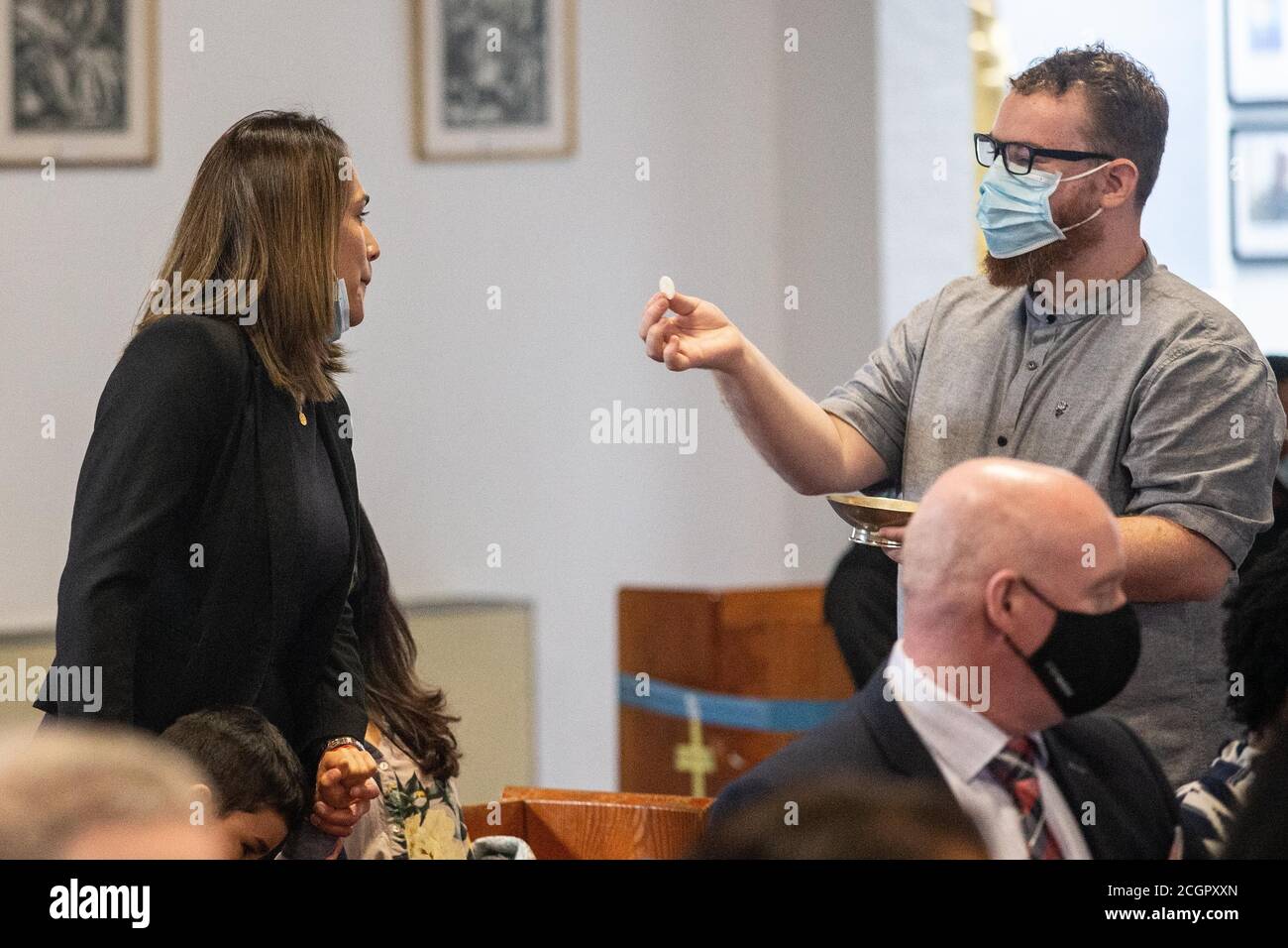 parishioner receives holy communion at Catholic Mass during Coronavirus ...