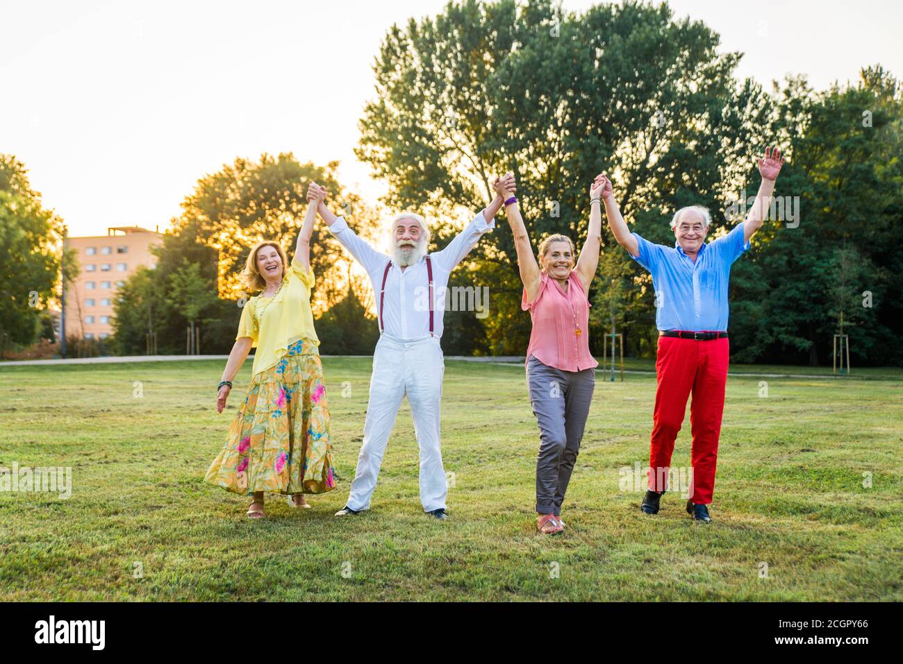 Group of youthful seniors having fun outdoors - Four pensioners bonding ...