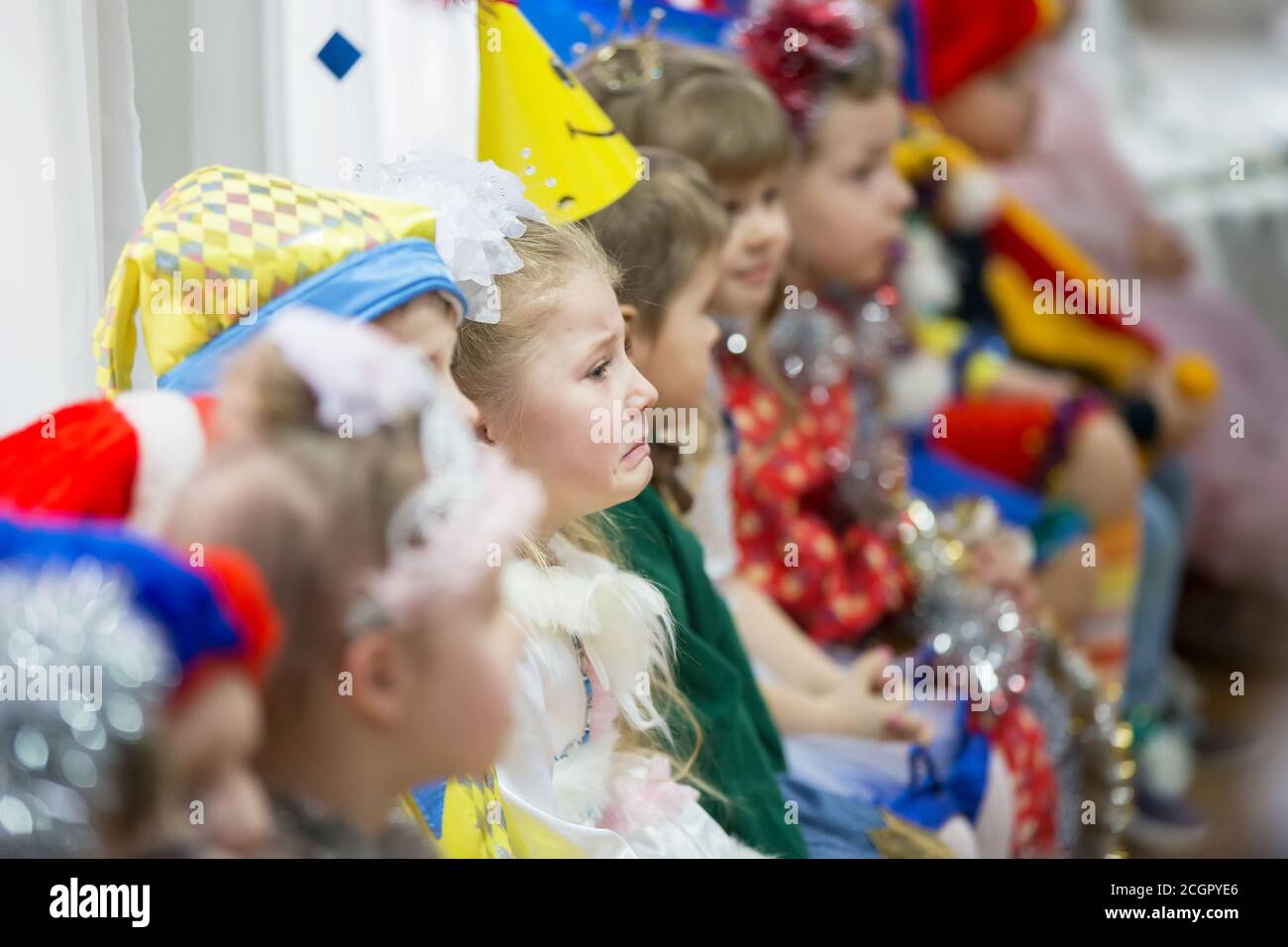 Group of children on holiday. The face of a sad child among happy ...