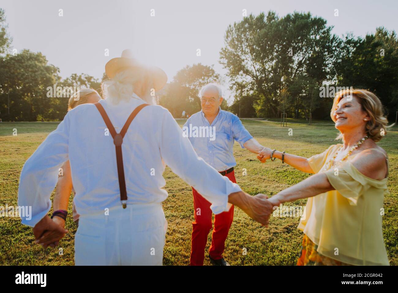 Group of youthful seniors having fun outdoors - Four pensioners bonding ...
