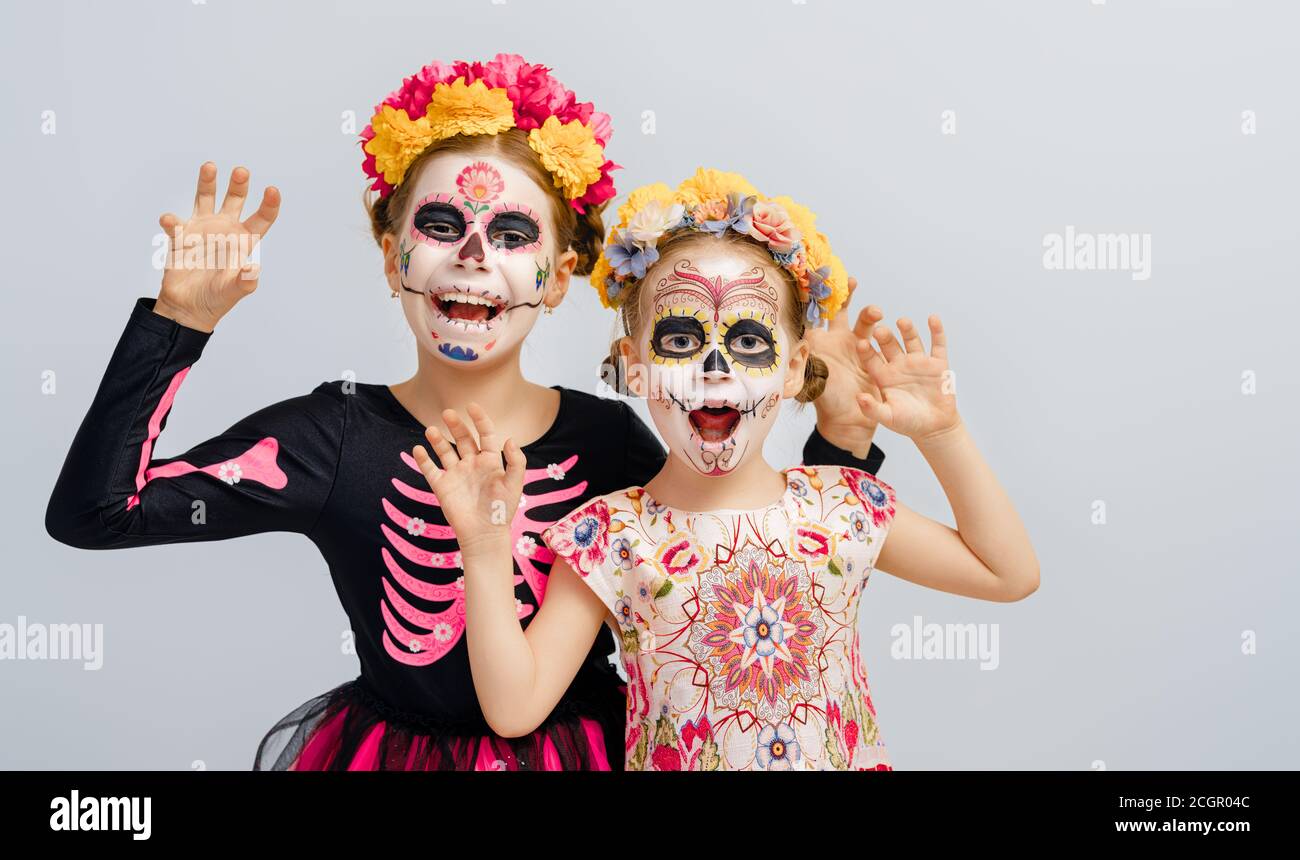 Adorable zombies in flower wreaths posing on white background. Happy ...