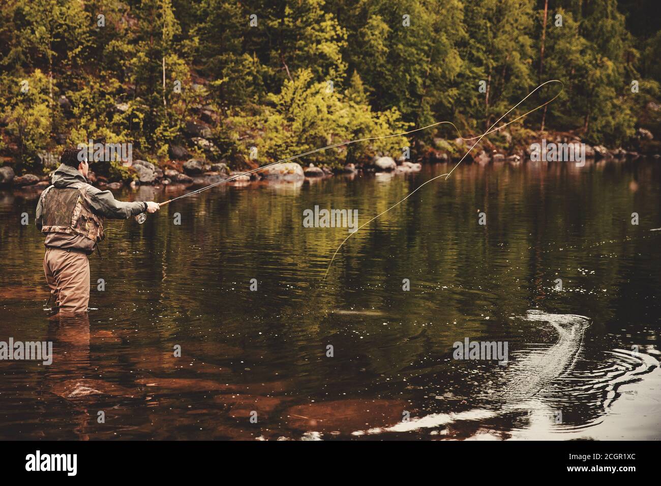 Coil of fly fishing rope, man hands holding rod Stock Photo - Alamy