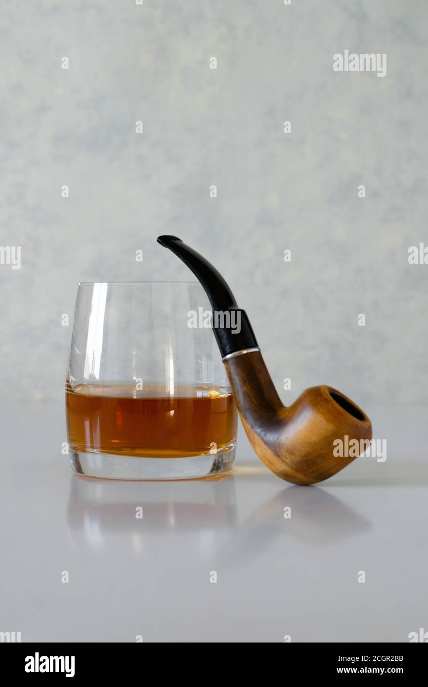 Isolated alcoholic drink, aged cognac and cigar pipe Stock Photo - Alamy